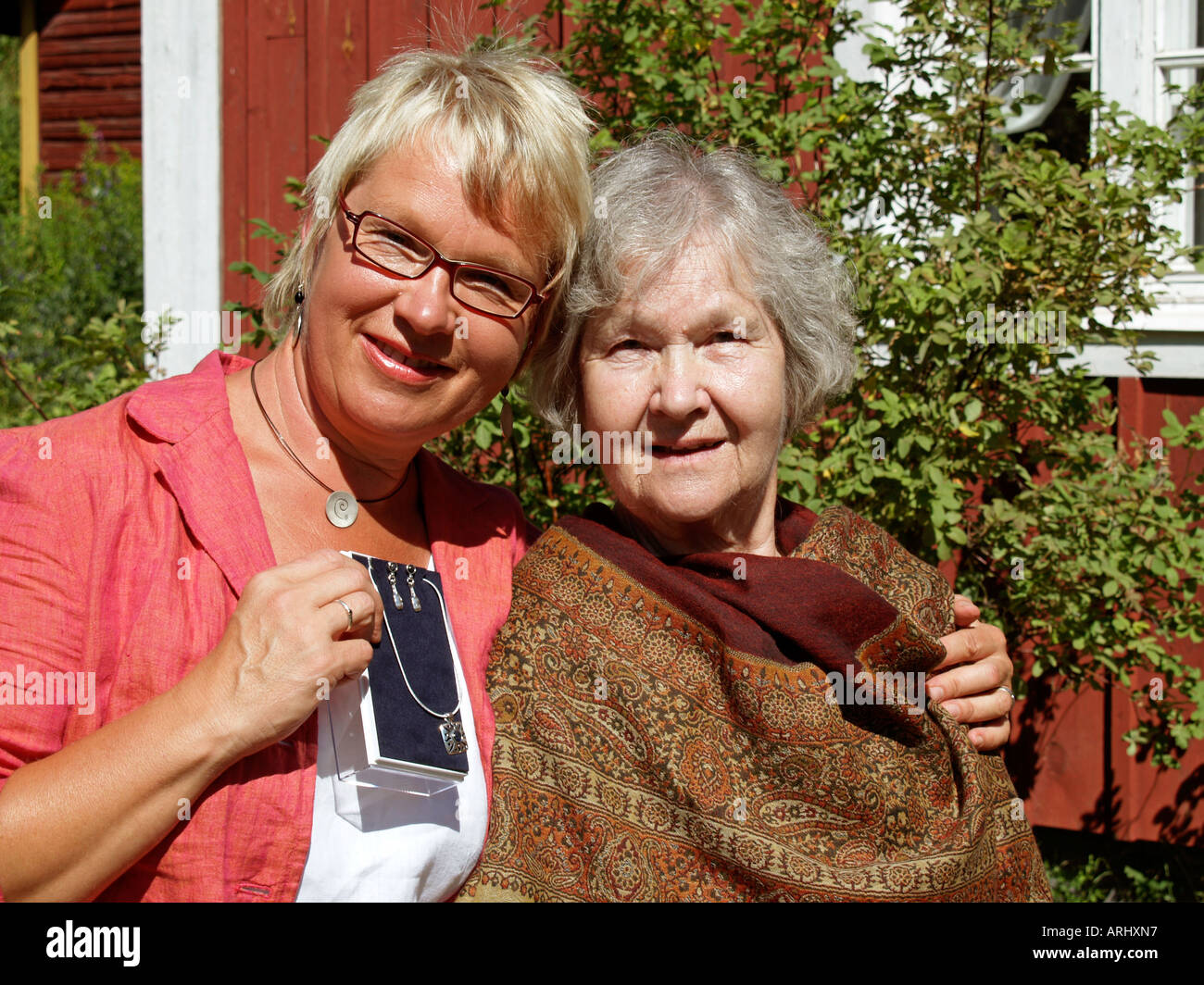 two generations mother and daughter old woman and a middle aged woman ...