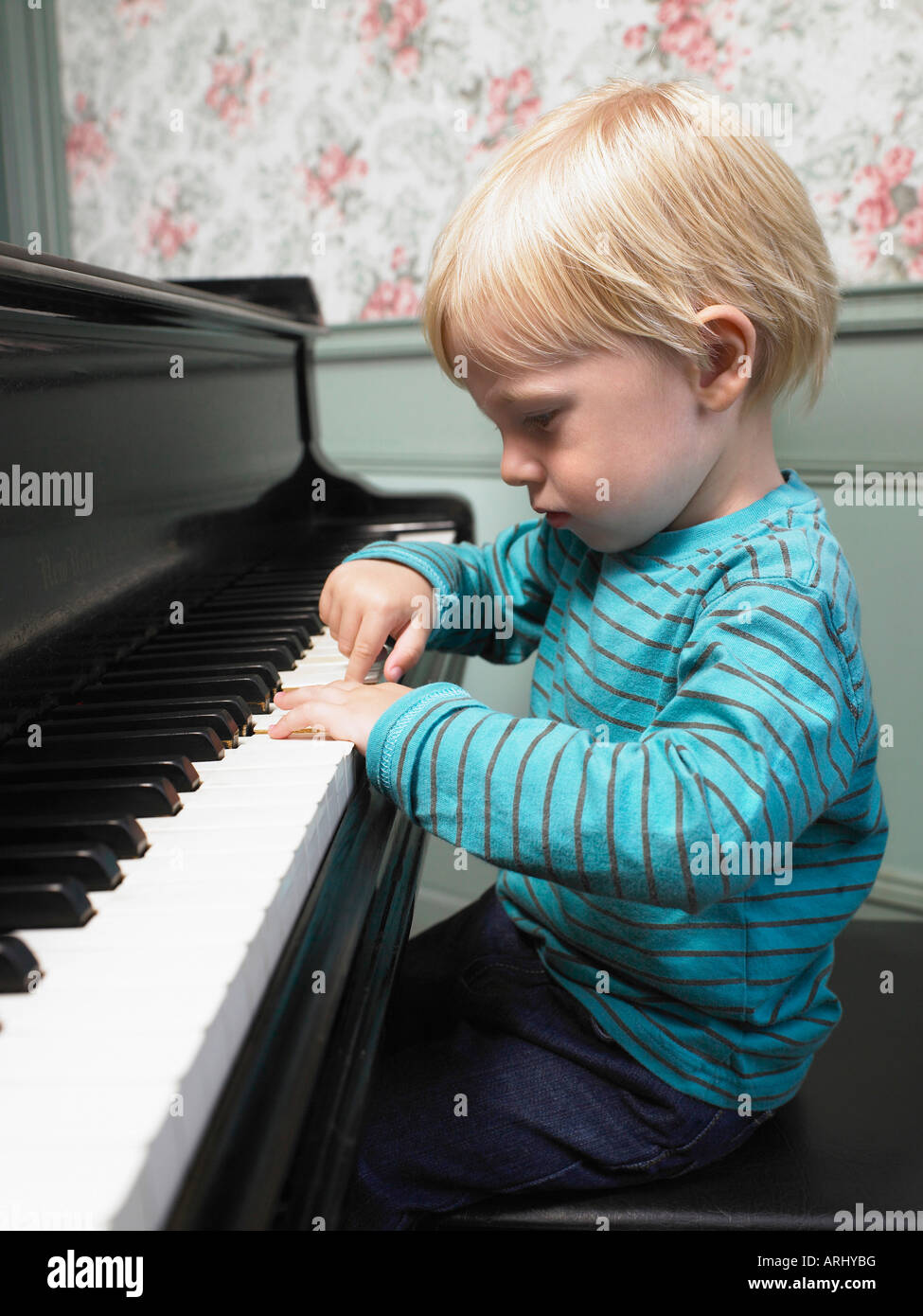 Little boy playing piano Stock Photo - Alamy