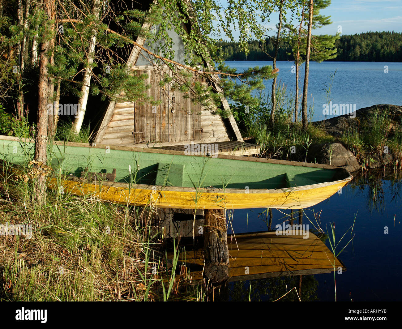 boathouse with rowing boat on the lakefront of a lake near by the town ...