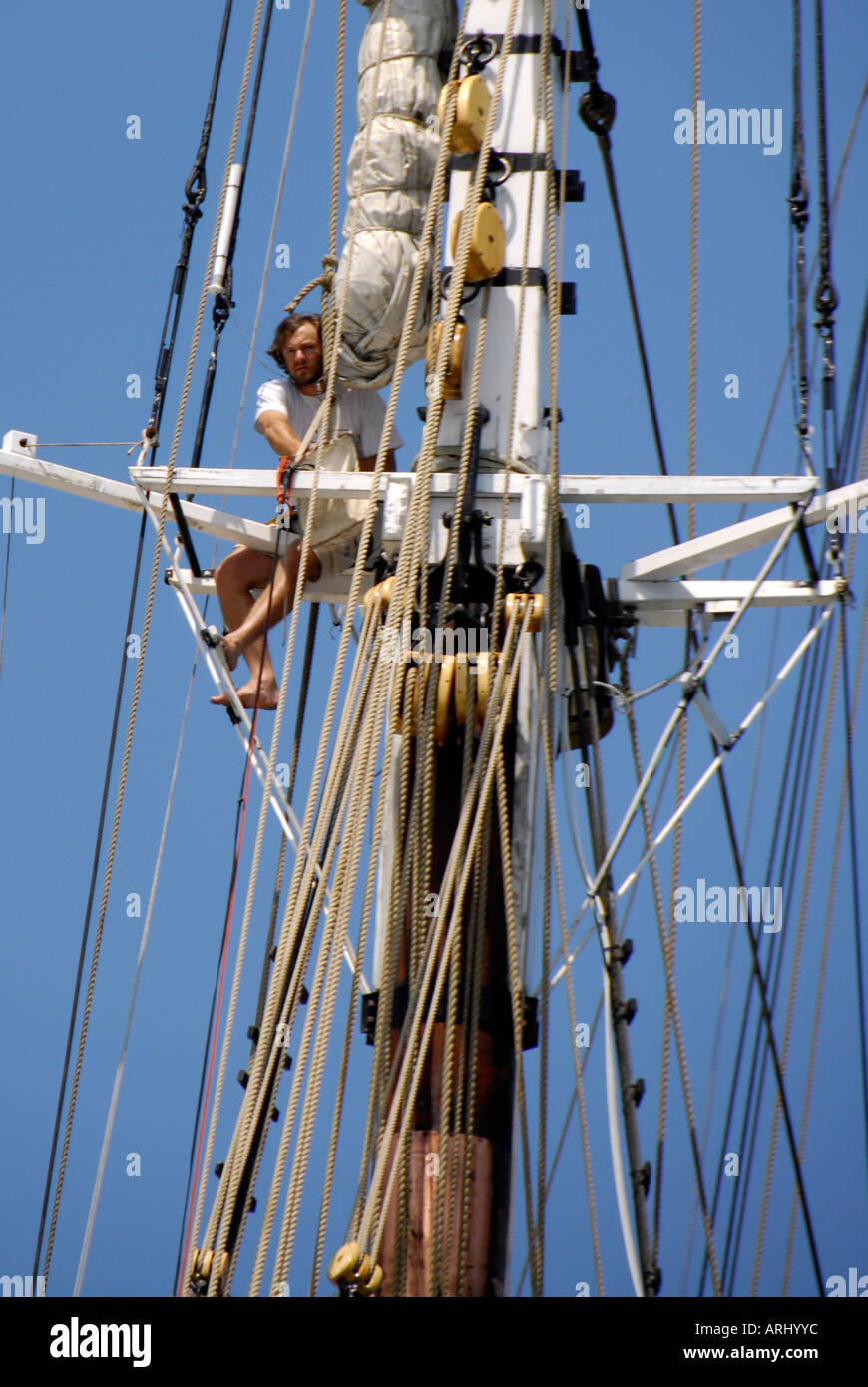 Ship hand effects repair on the mast of a tall ship Stock Photo - Alamy