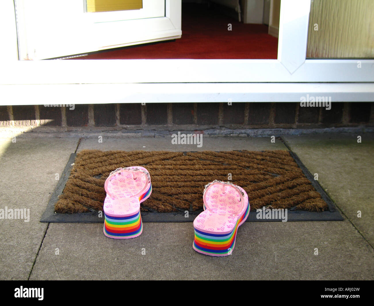 Flip flop sandals at house door Stock Photo - Alamy