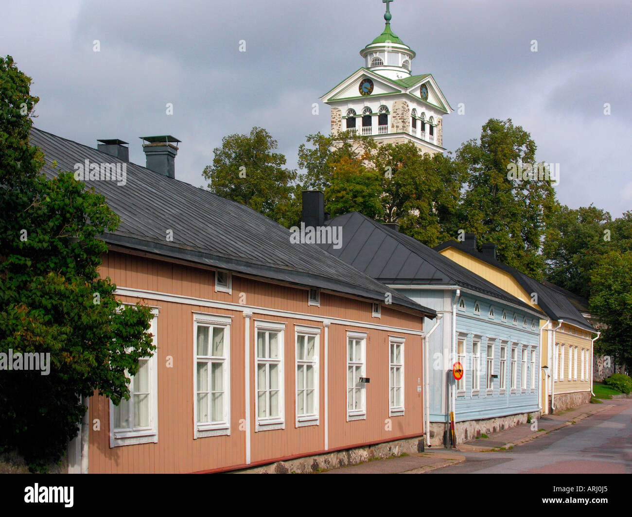 facades of old timber buildings wooden houses with the tower of the ...