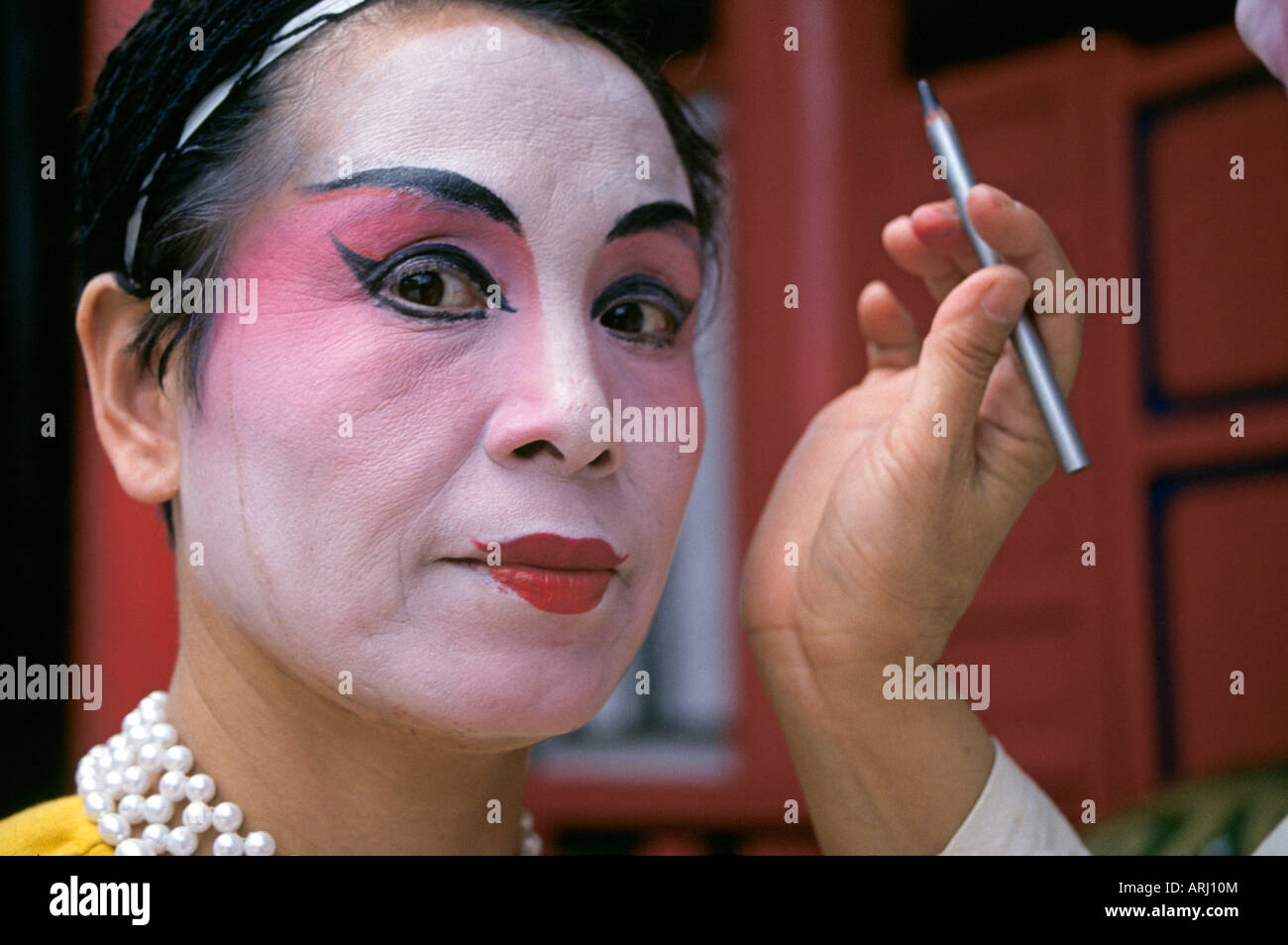 Man putting face paint on hi-res stock photography and images - Alamy