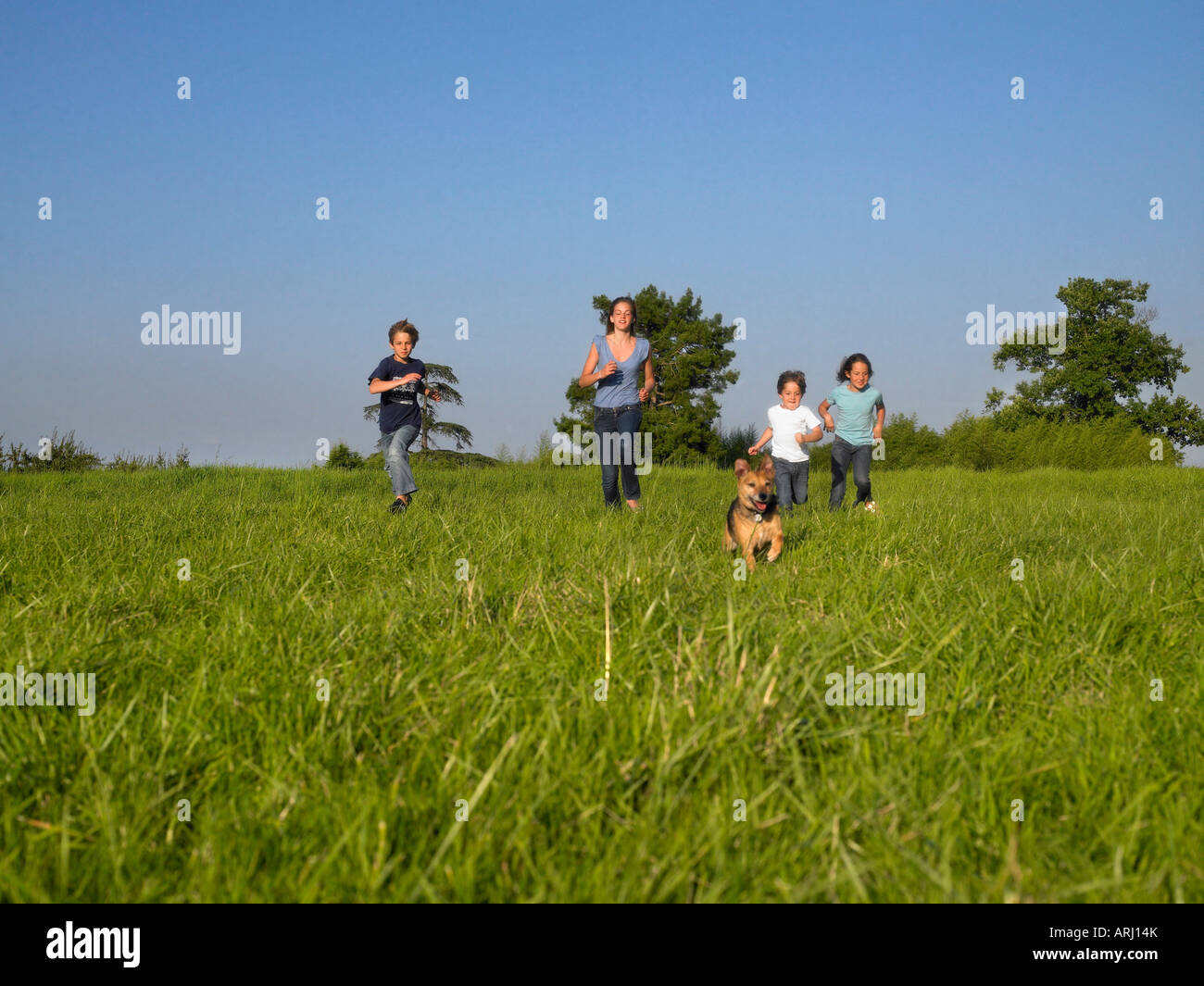 Group of kids running in a field Stock Photo - Alamy