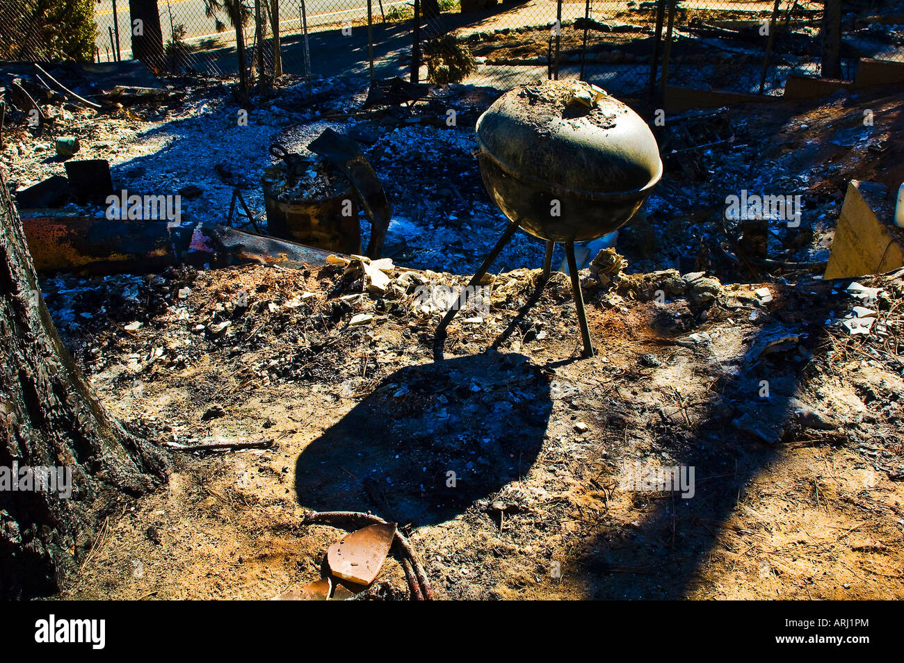 Burnt barbecue grill sitting in the ashes of a home lost in the October ...
