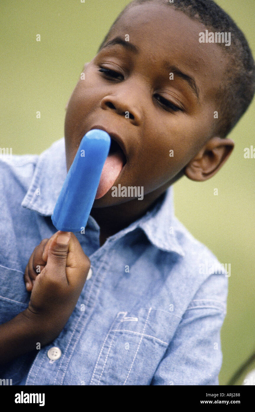 Boy eating popsicle african hi-res stock photography and images - Alamy