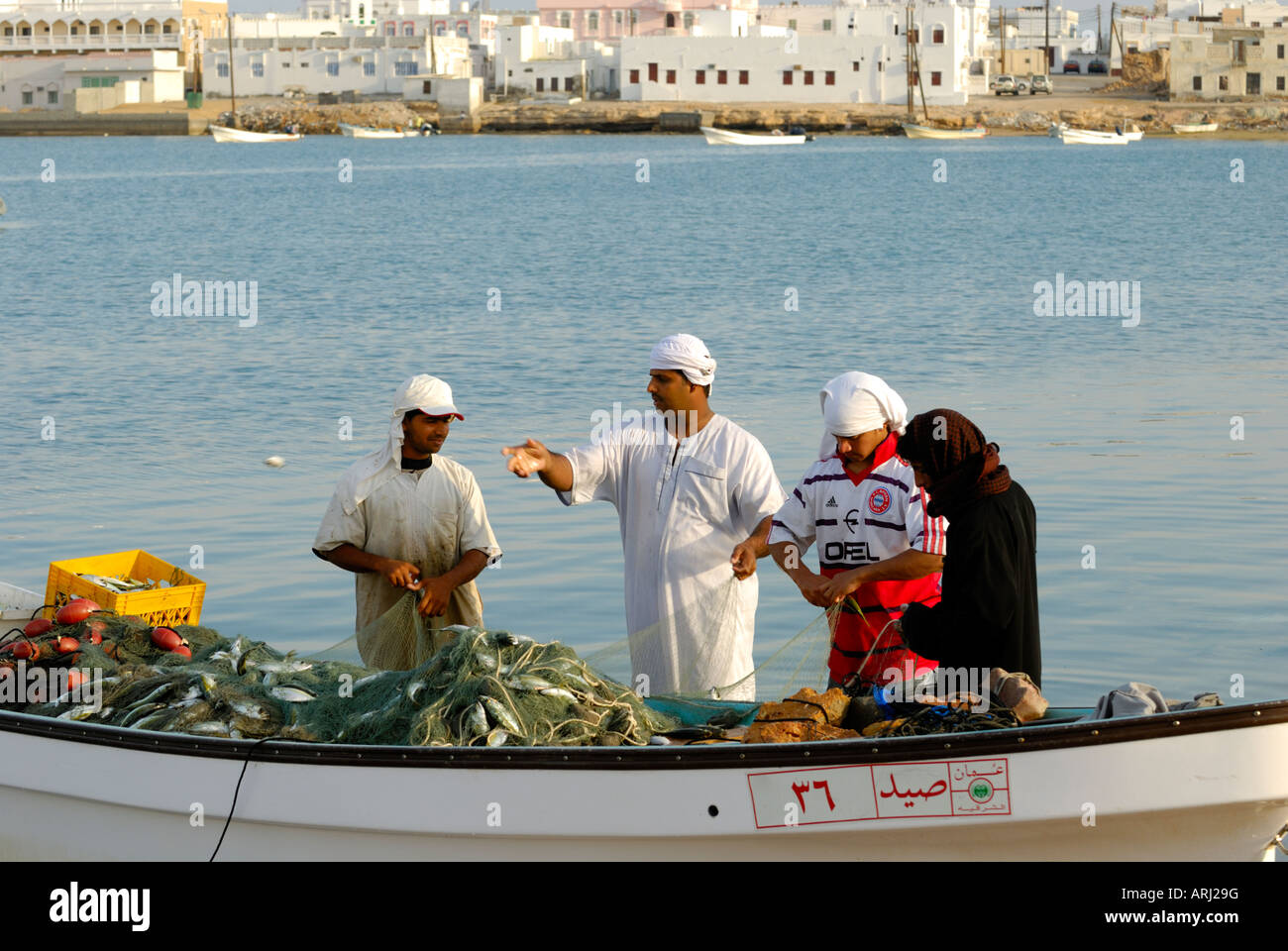 Fishermen processing their catch, Sur, Oman Stock Photo - Alamy