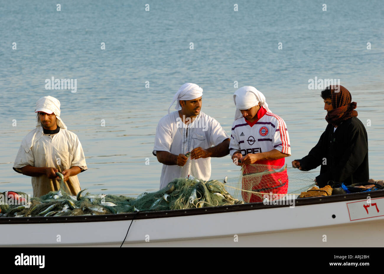 Fishermen processing their catch, Sur, Oman Stock Photo - Alamy