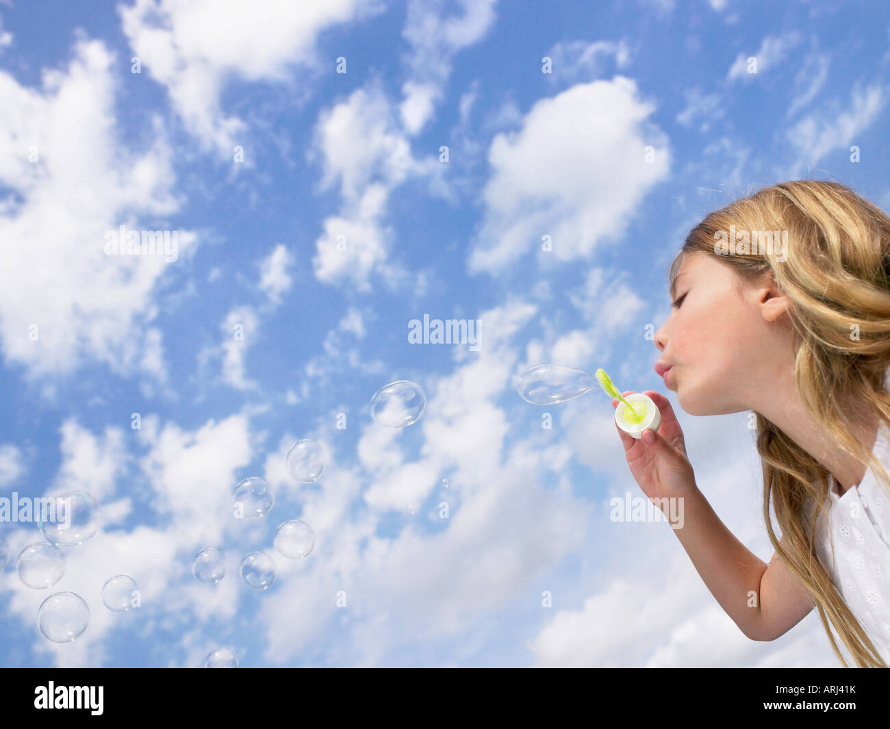 Little girl blowing bubbles Stock Photo - Alamy