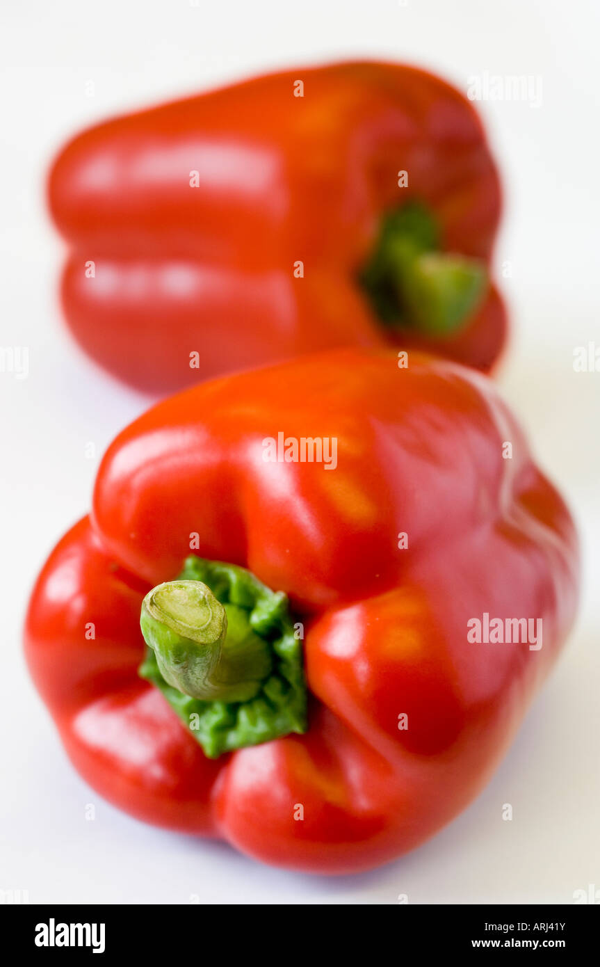 Red organic Bell Peppers against a white background Stock Photo - Alamy