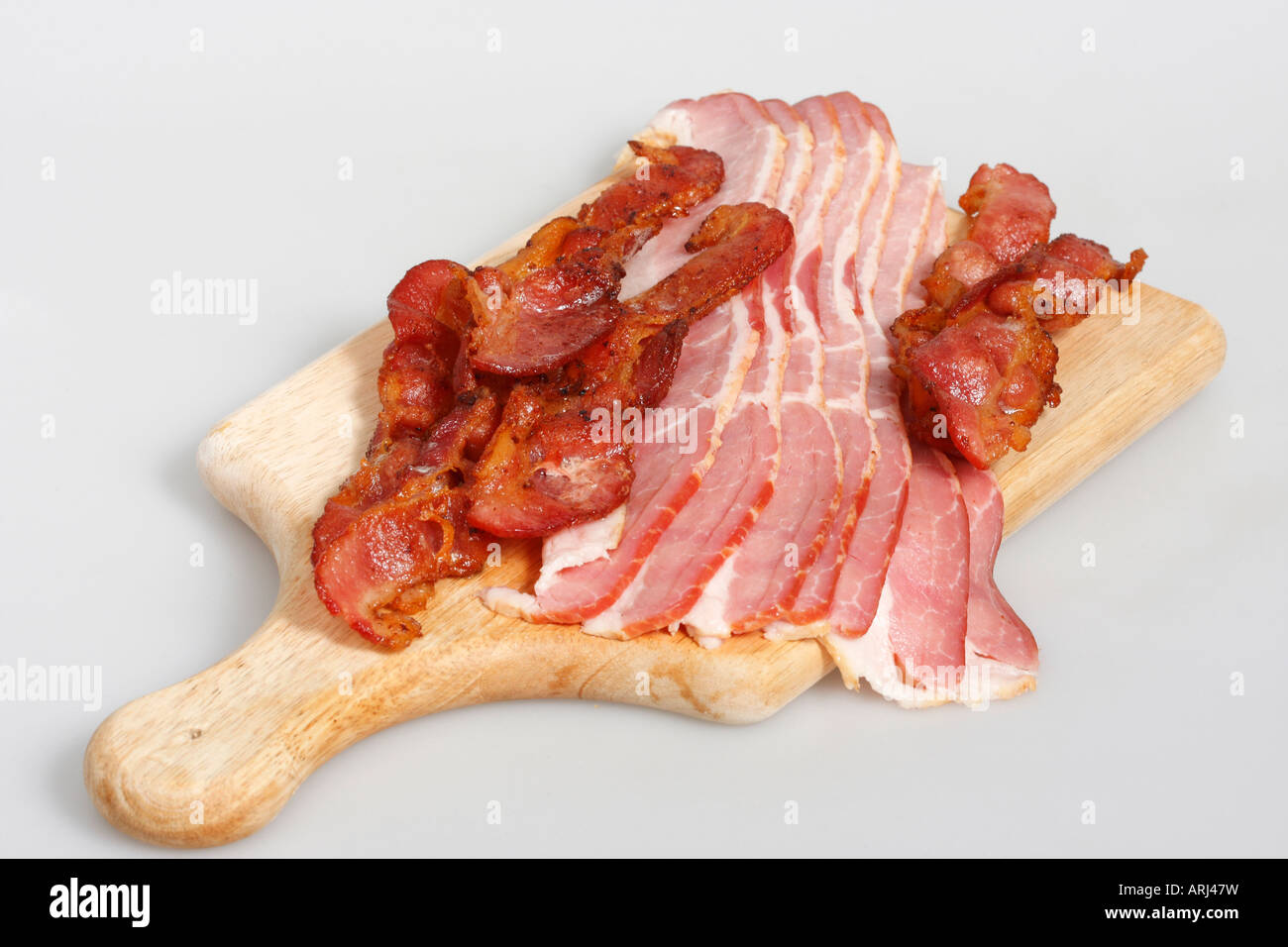 Bacon raw with crispy strips pork bacon on a wooden board meat fat food ...