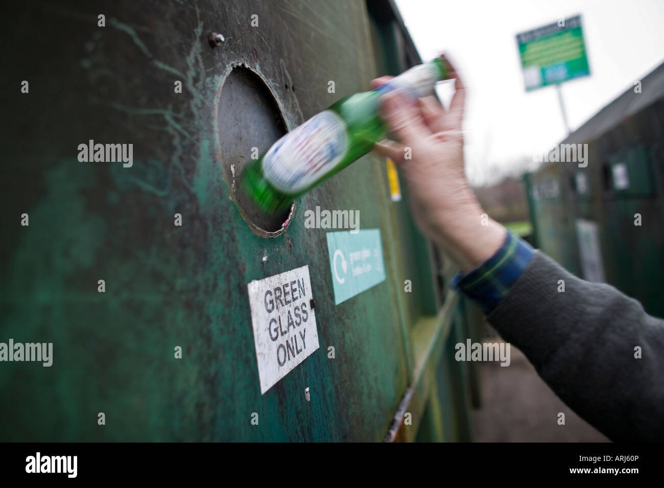 Green glass recycling bin at a recycling centre, UK Stock Photo - Alamy