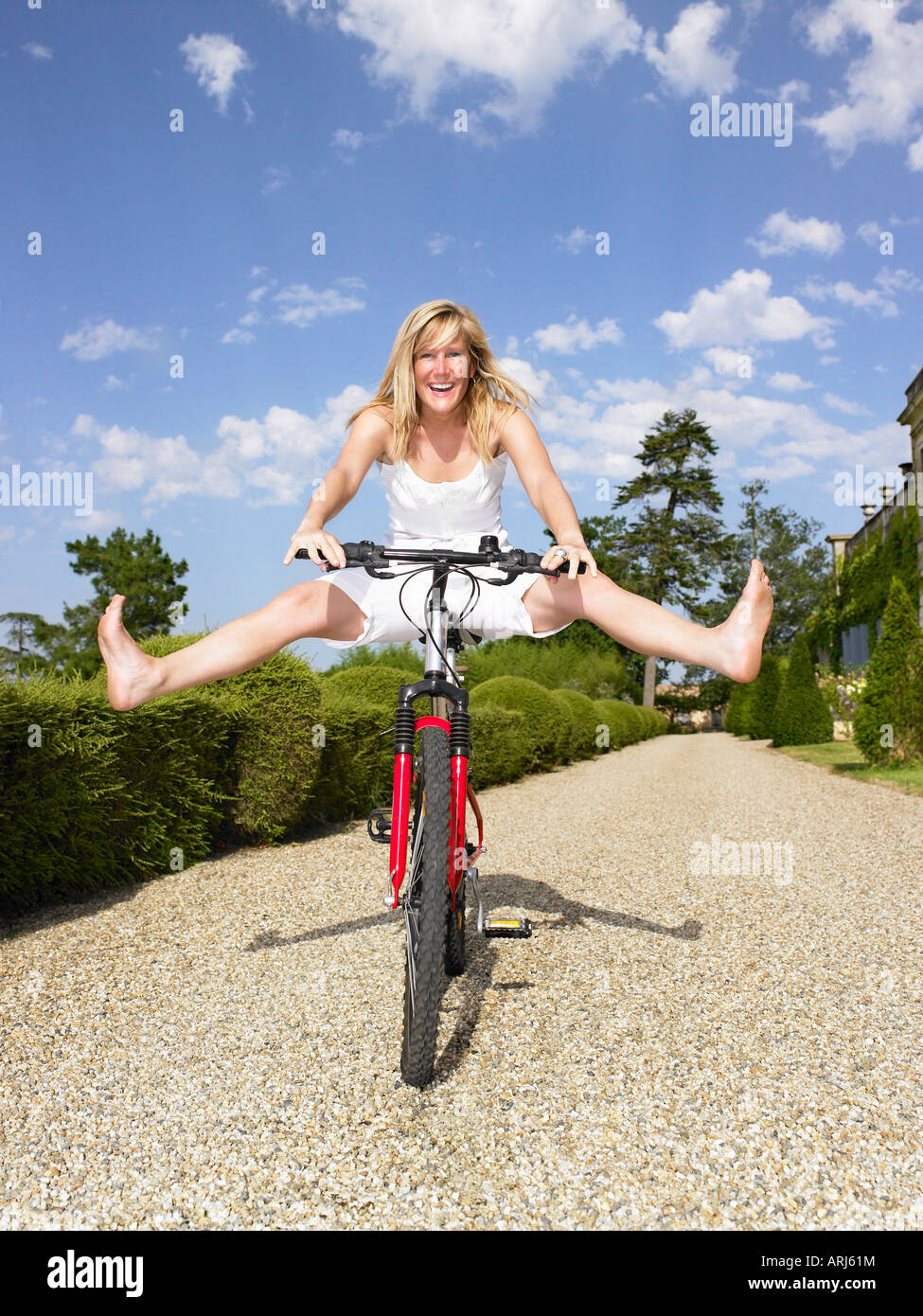 Woman playing on her bicycle Stock Photo - Alamy