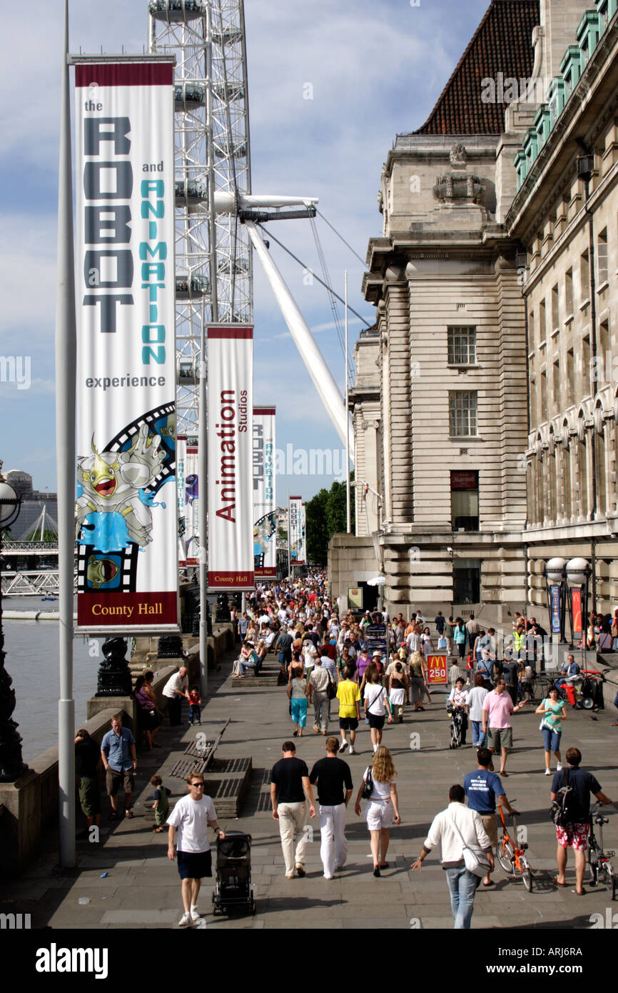 Crowd walking along The Queens Walk South Bank London Stock Photo - Alamy