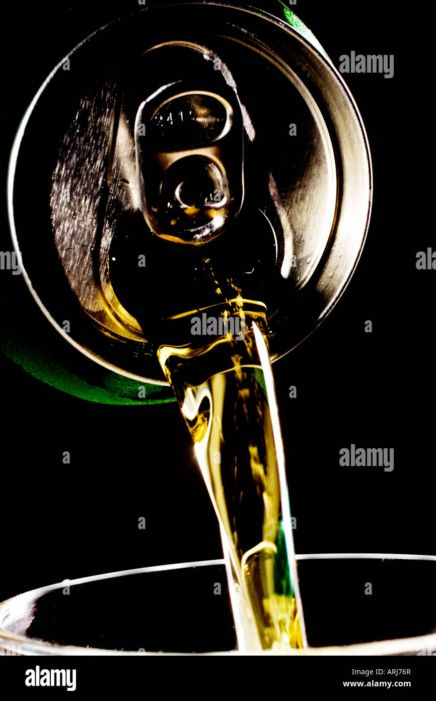 A can of lager being poured into a glass Stock Photo - Alamy