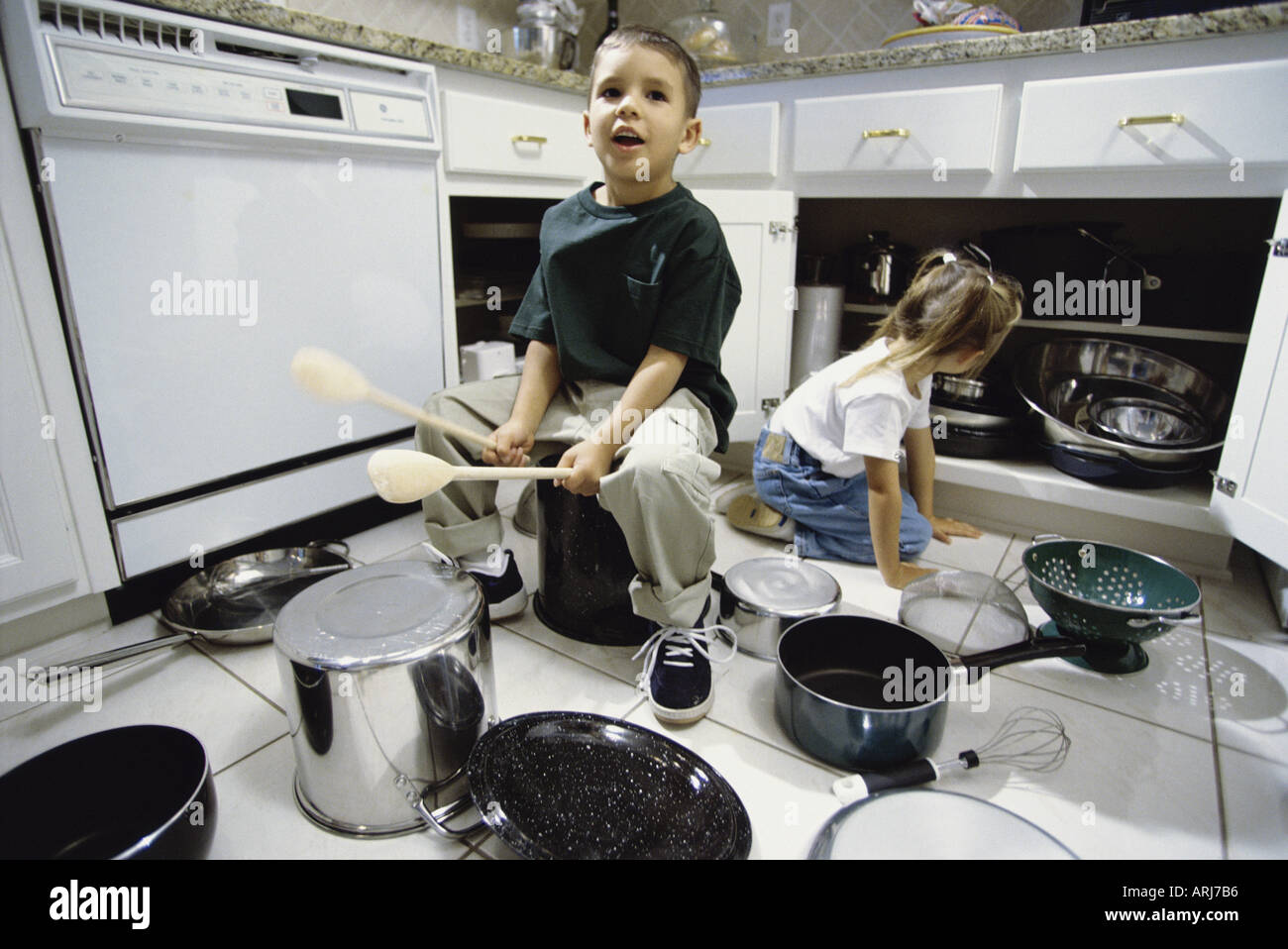 Kids playing with kitchen pans hi-res stock photography and images - Alamy