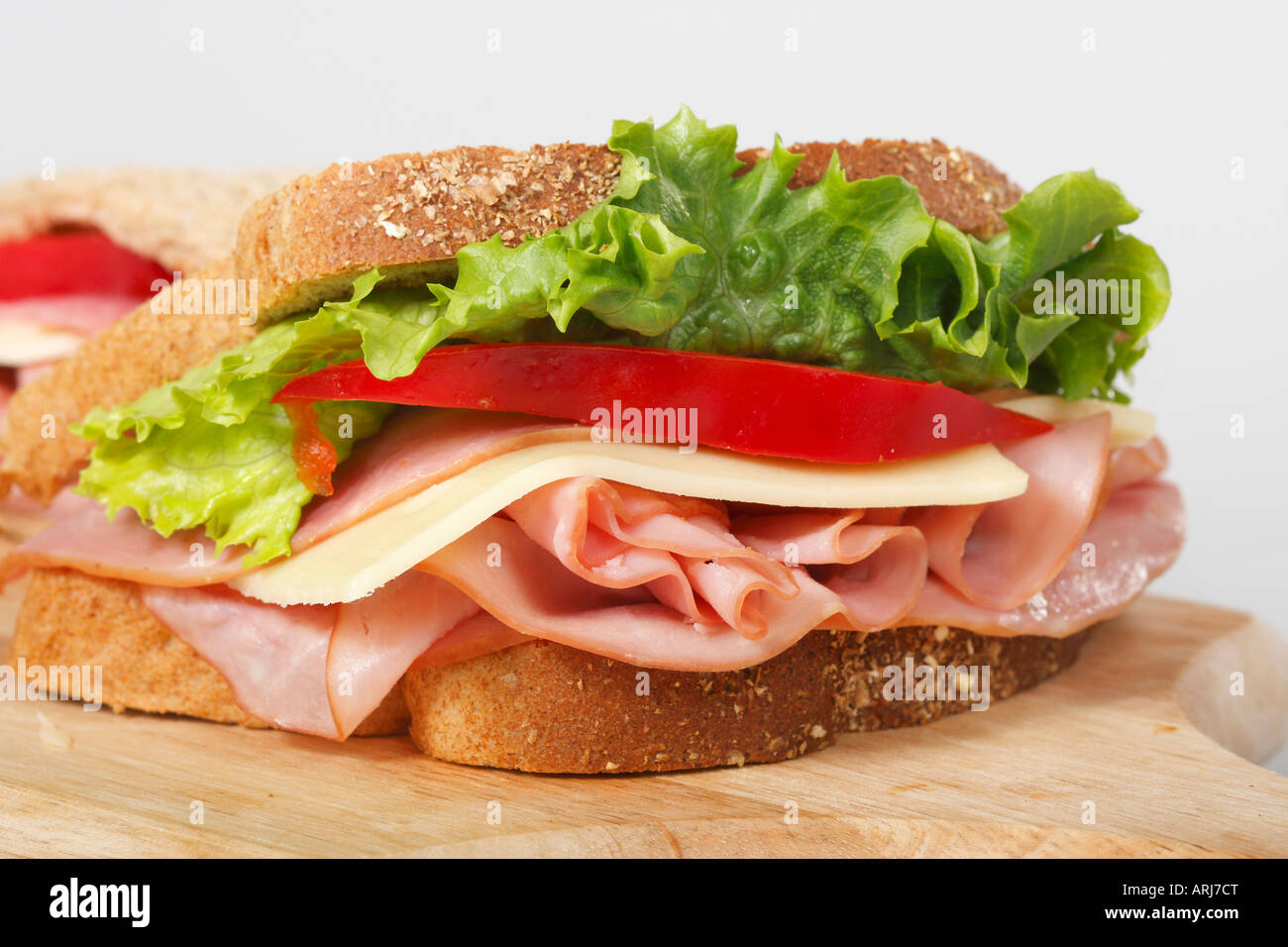 Cross section of sandwich a white bread with ham and vegetables on a ...