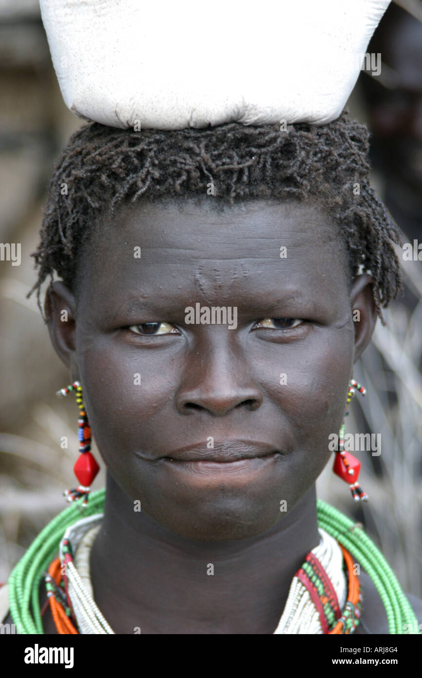 Toposa woman carrying a bucket on her head, portrait, Sudan Stock Photo ...