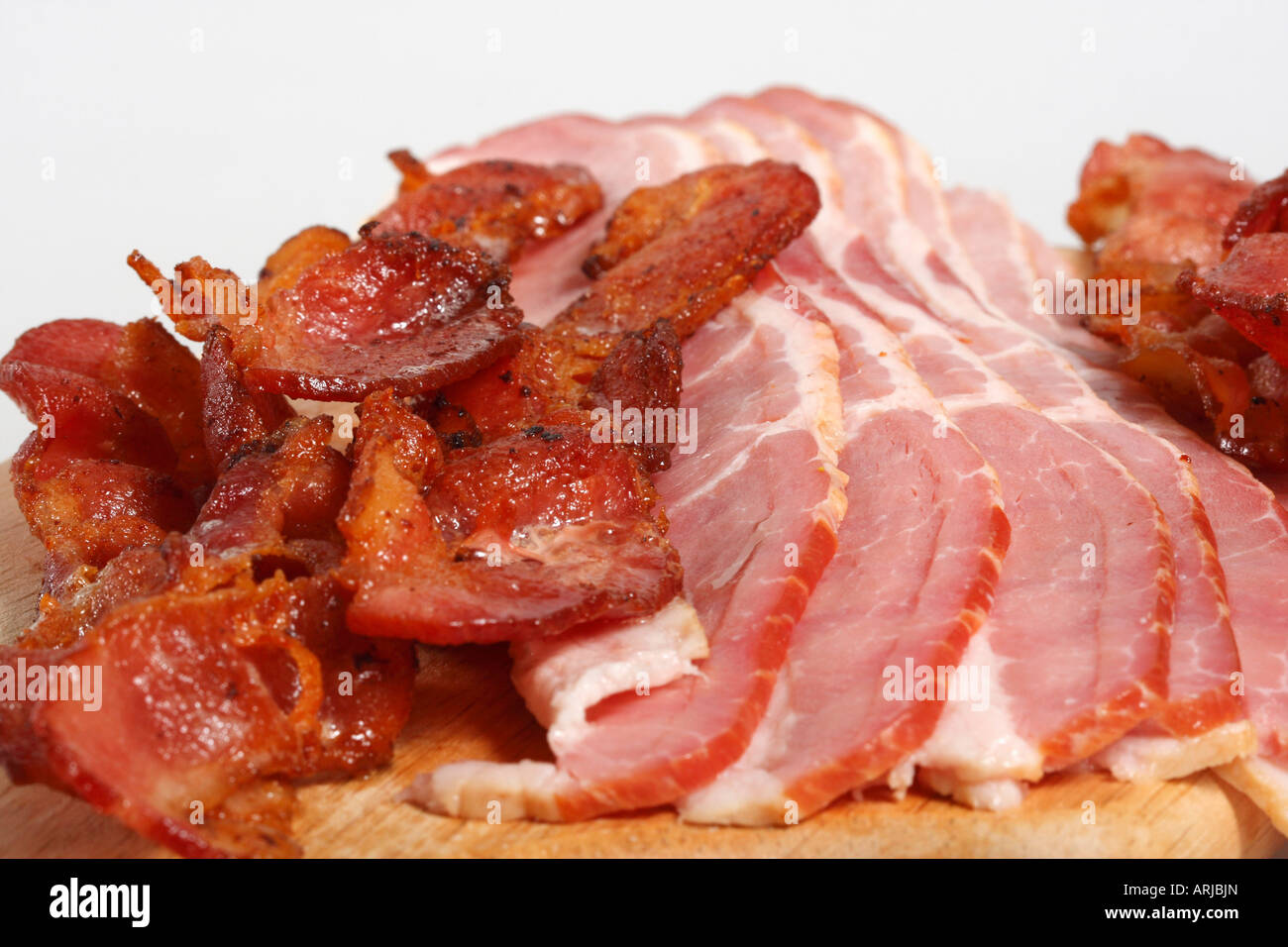 Bacon raw with roasted crispy strips pork bacon meat a fast fat food of ...