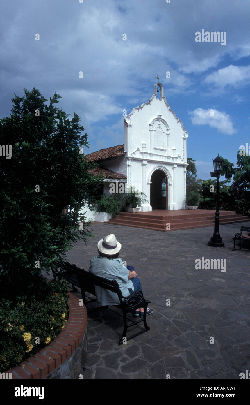 White church and woman tourist wearing a Panama hat at Mi Pueblito ...