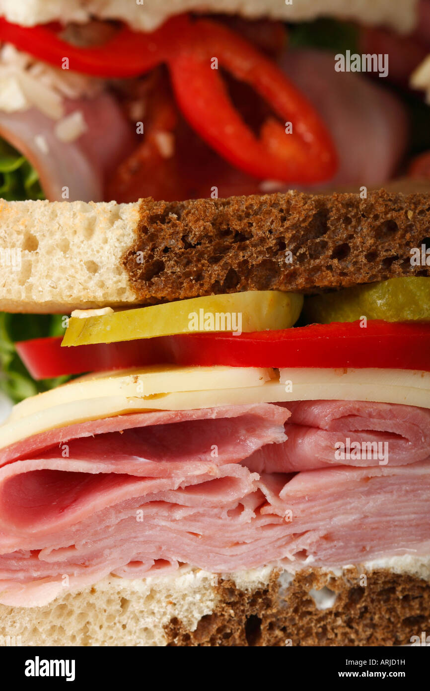 Cross section of sandwich bread with ham and Swiss cheese garnish cut ...
