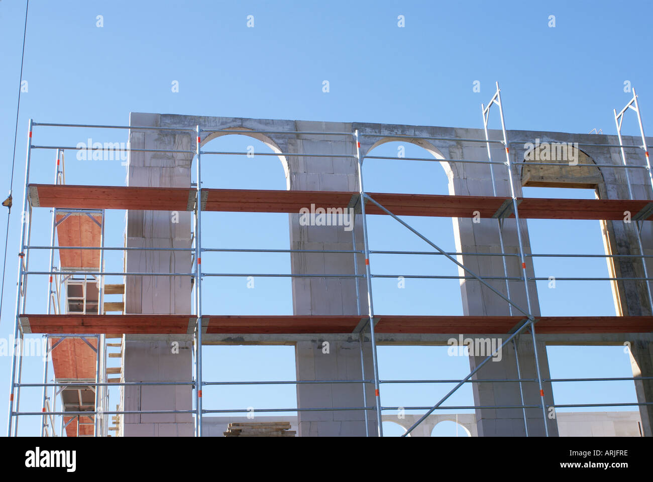 building under construction with scaffolding and wall being built Stock ...