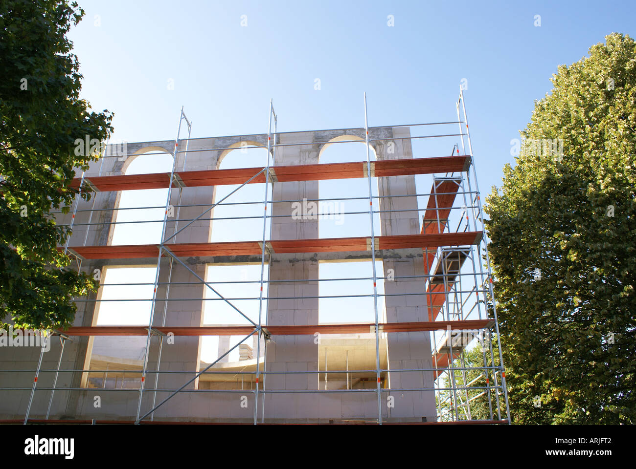 building under construction with scaffolding and wall being built Stock ...