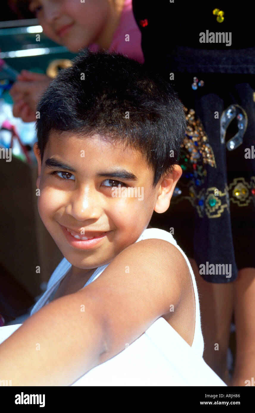 Happy Mexican American boy age 7 smiling watching Cinco de Mayo parade ...