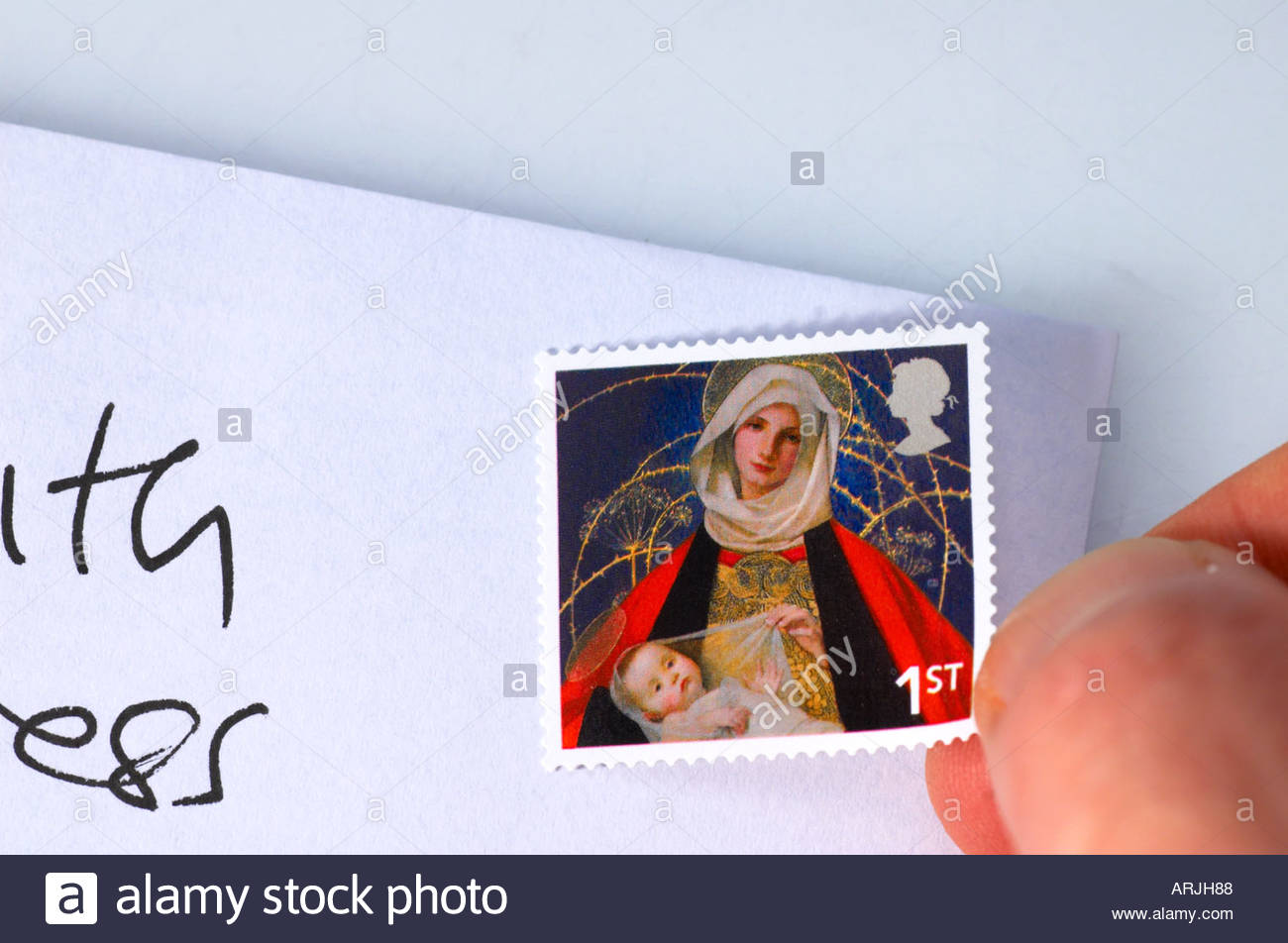 Placing a Christmas first class stamp on a envelope Stock Photo - Alamy
