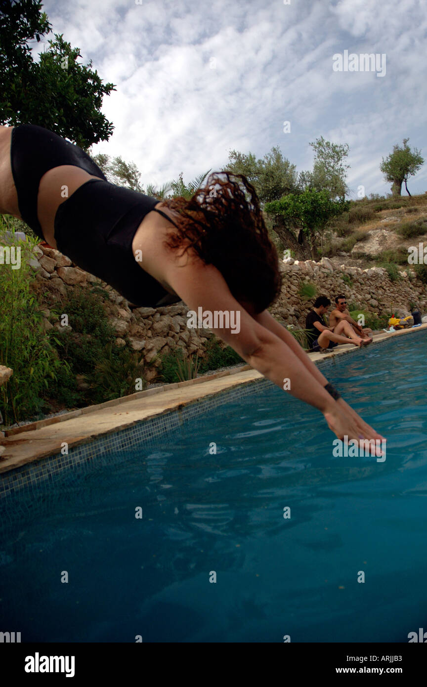 Woman diving into a pool in Pinos del Valle Spain Stock Photo - Alamy