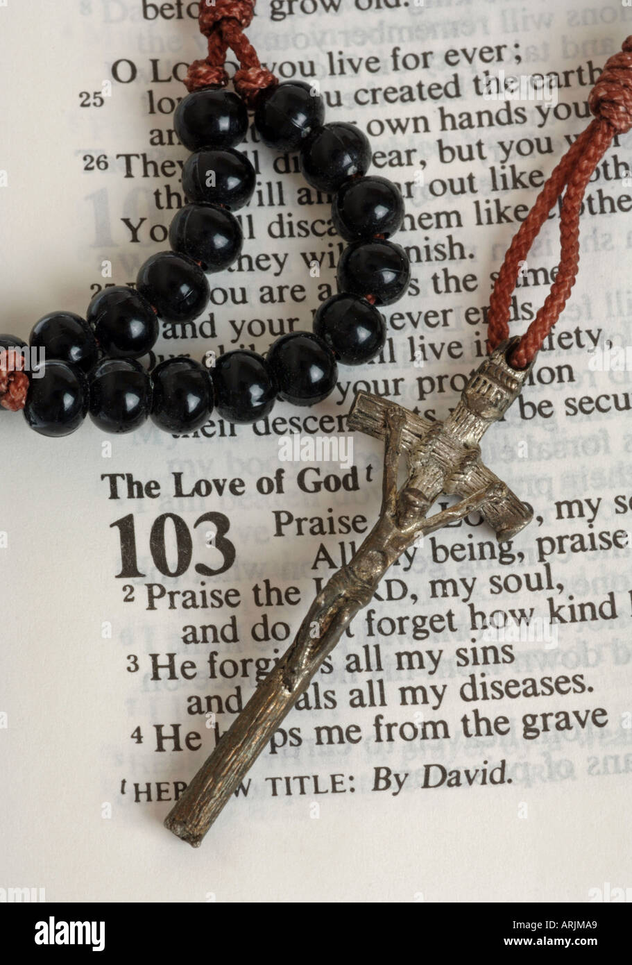 Rosary on a Bible showing the words The Love of God Stock Photo - Alamy