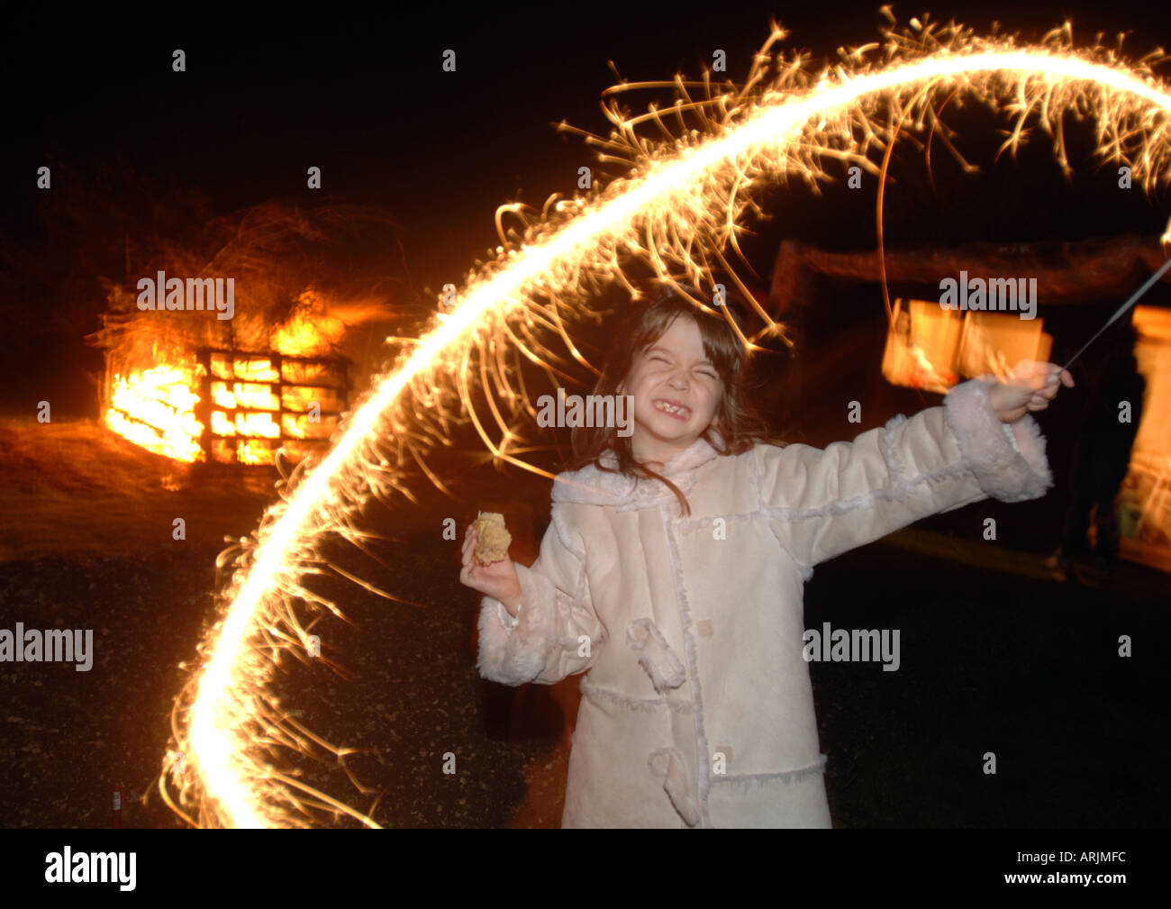 A girl plays with a sparkler on bonfire night Stock Photo - Alamy