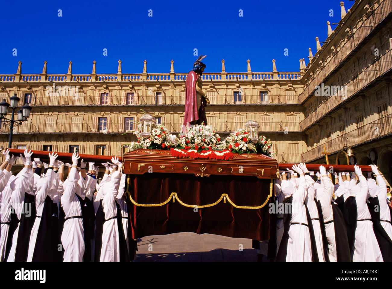 Penitents lifting the Jesus Christ carriage during Semana Santa ...