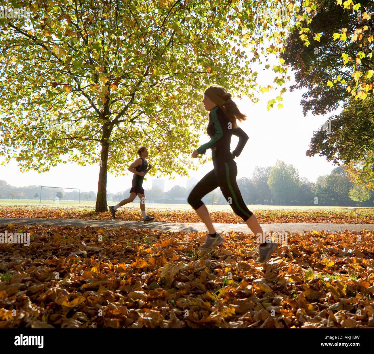 Young woman and man running Stock Photo - Alamy