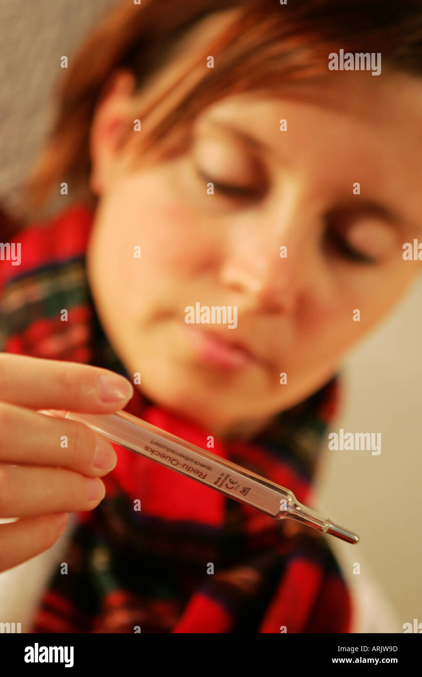 DEU, Germany : Health, cold, sickness. Young woman measures her blood ...