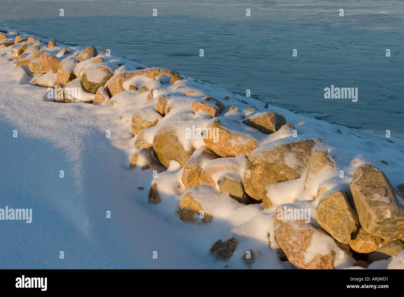 Snow covered stone embankment at breakwater , Finland Stock Photo - Alamy