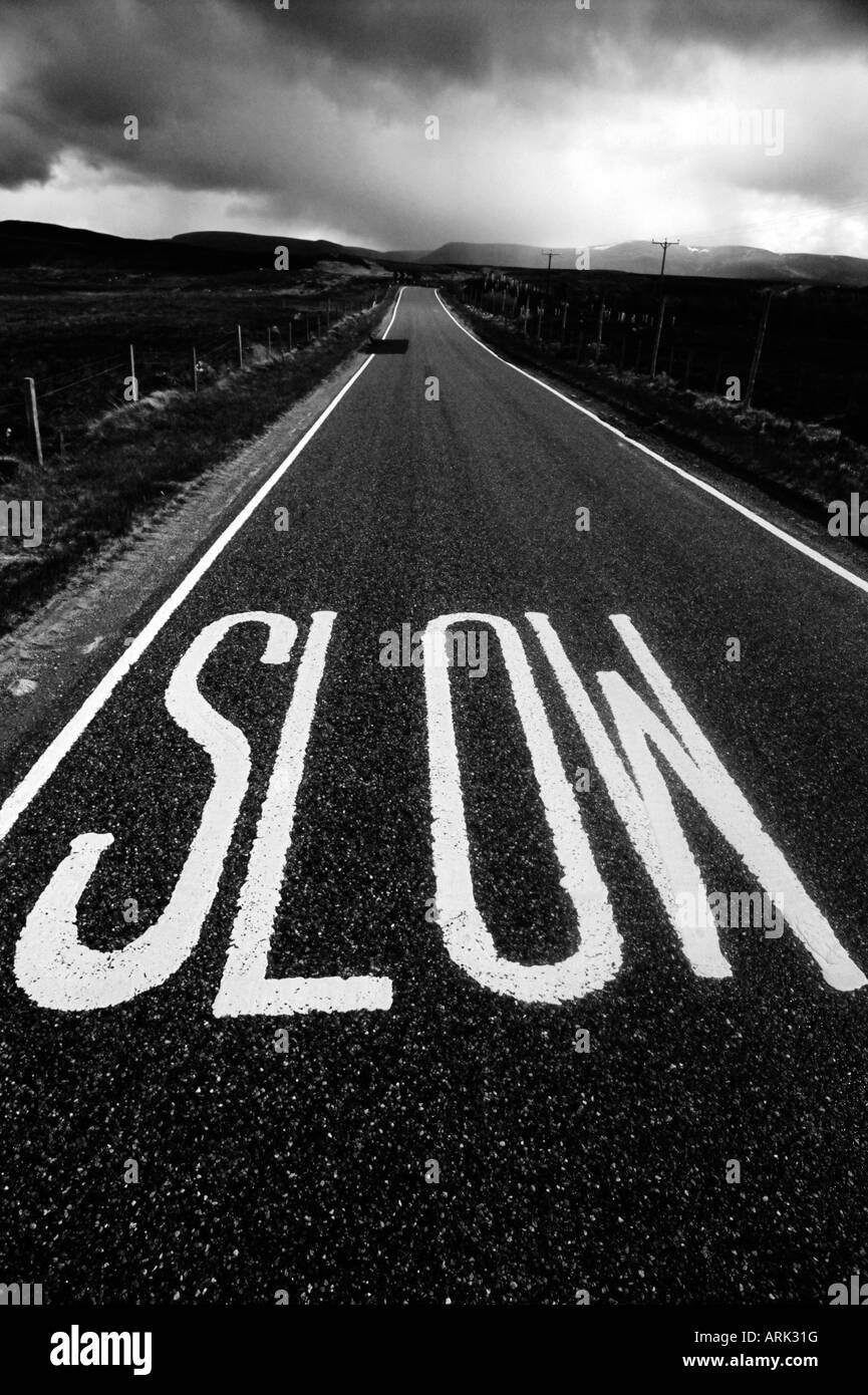 Slow sign on road, Scotland Stock Photo - Alamy