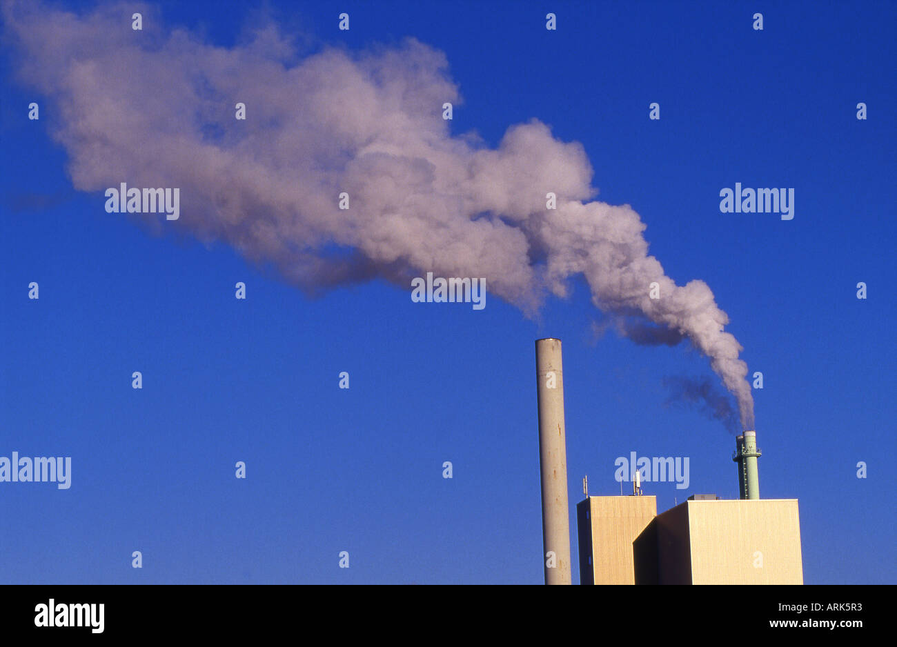 Symbolic photo: chimney and smoke of a destructor. Air pollution ...