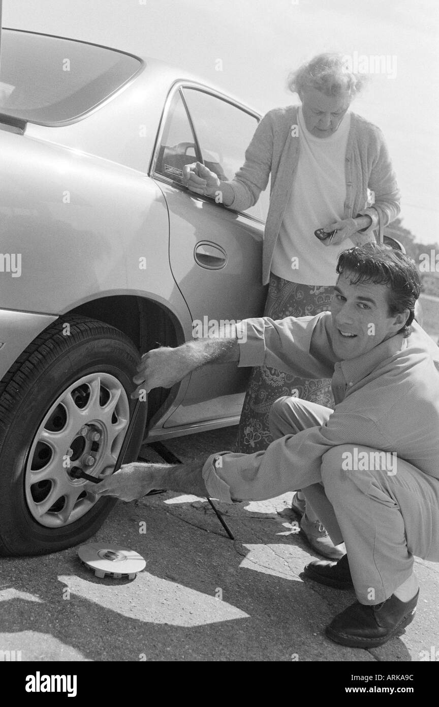 Fixing flat tire Black and White Stock Photos & Images - Alamy