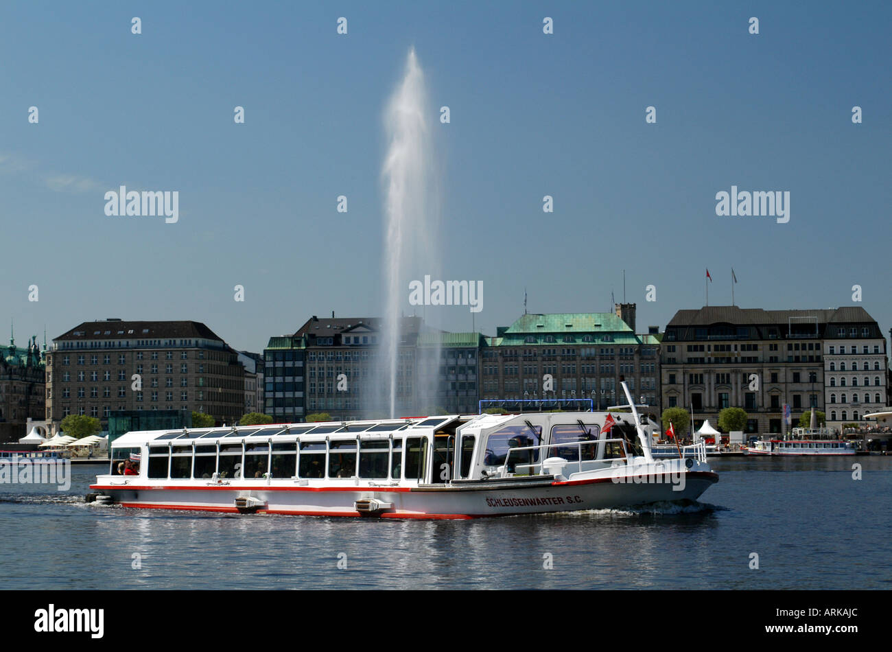 An excursion boat on the lake Binnenalster in front of the Alster ...
