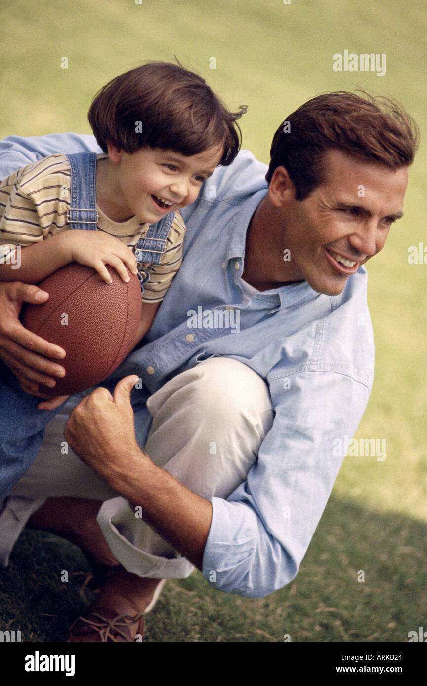 Father football hugging son hi-res stock photography and images - Alamy