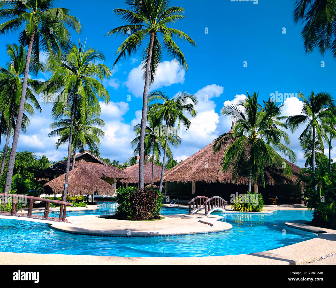Resort pool with wigwams all around Stock Photo - Alamy