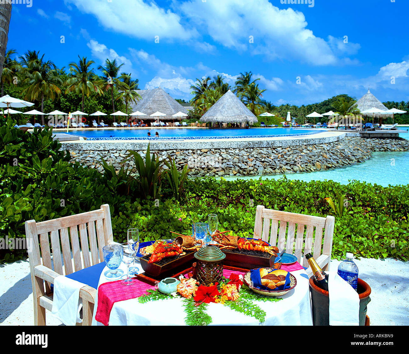 Dining exotic cuisine looking over the resort pool in Southeast Asia ...