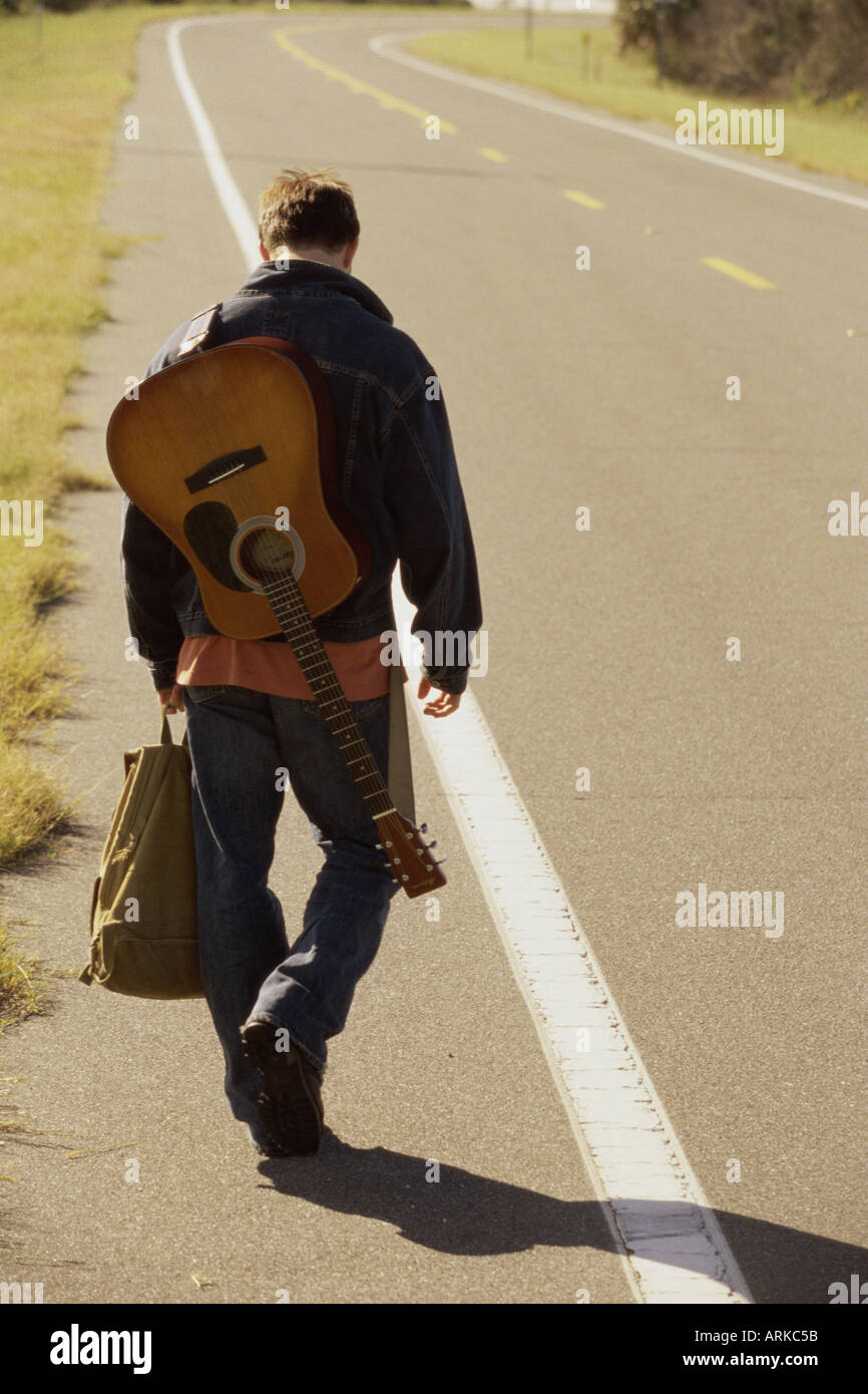 Drifter man guitar walking outdoors hi-res stock photography and images ...