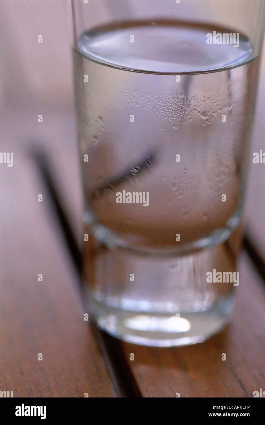 Close-up of a single glass of water on a table Stock Photo - Alamy