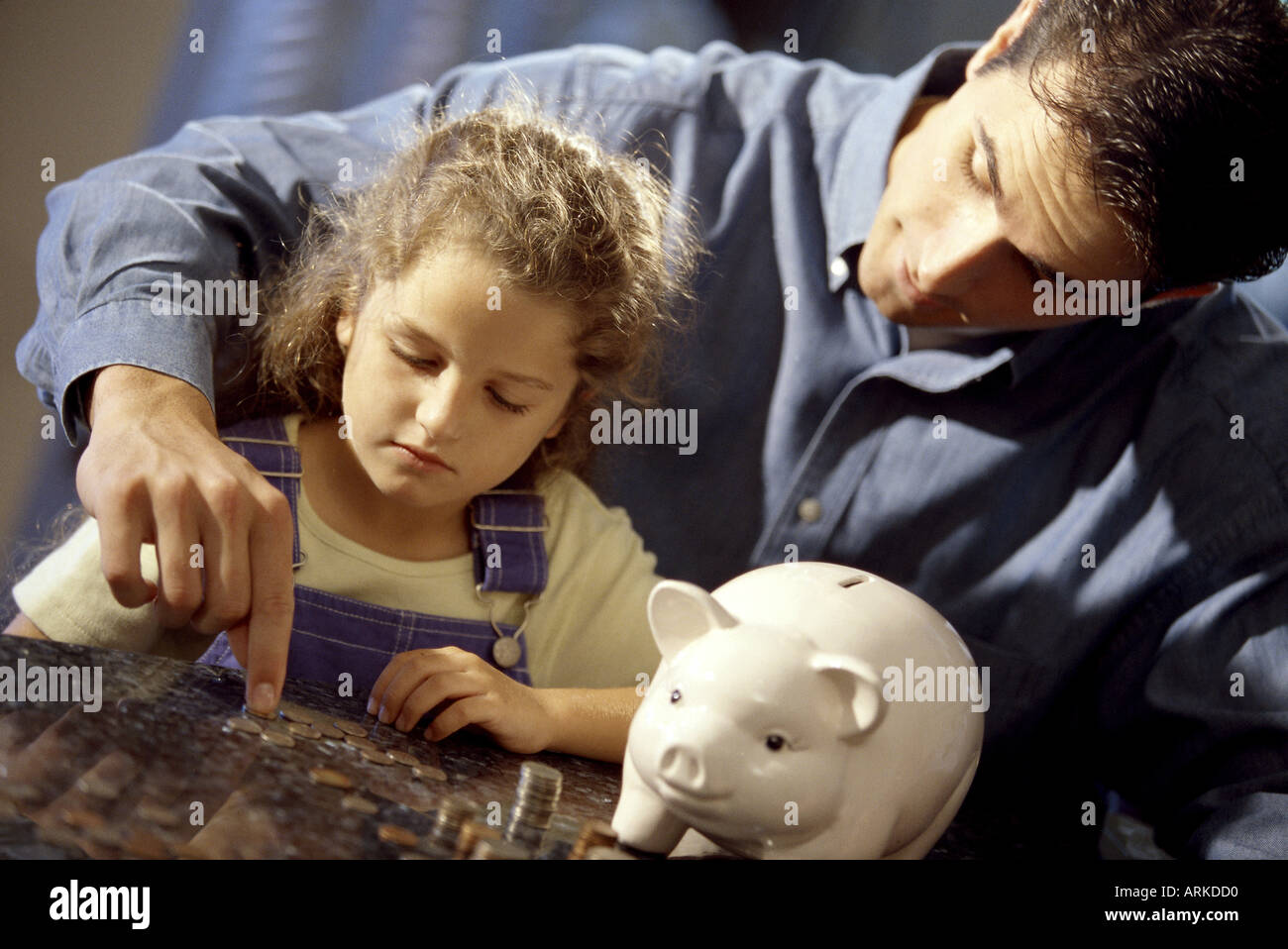 Father helping daughter count money hi-res stock photography and images ...