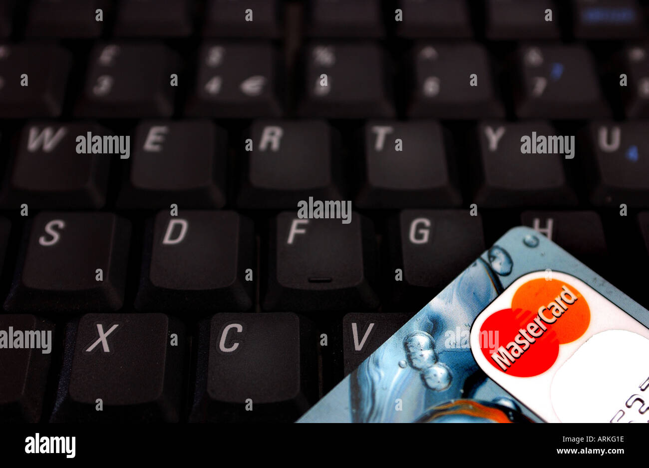 A credit card lying on top of a computer keyboard to illustrate ...