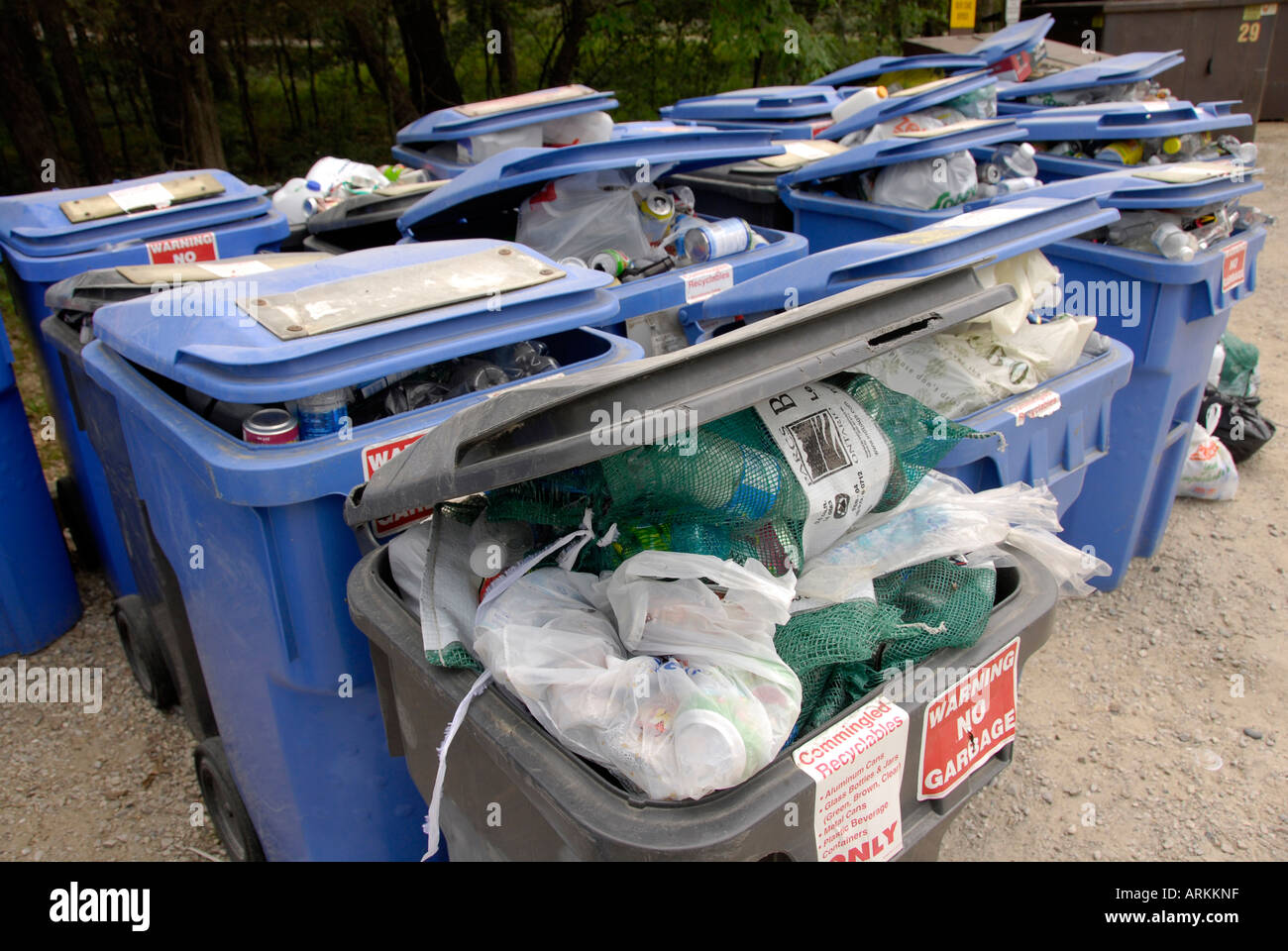 Separate trash containers are set up in a campground to recycle common ...