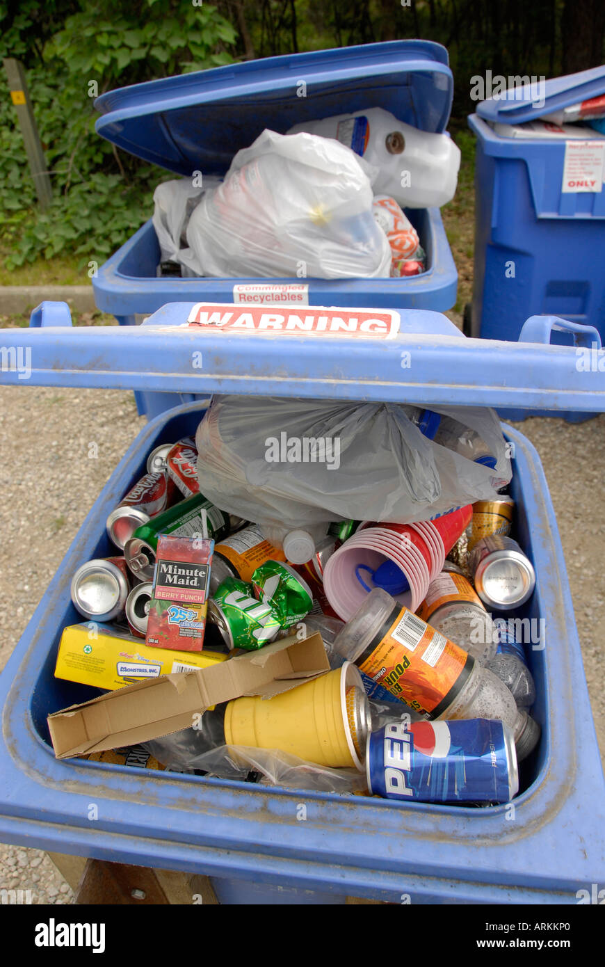 Separate trash containers are set up in a campground to recycle common ...