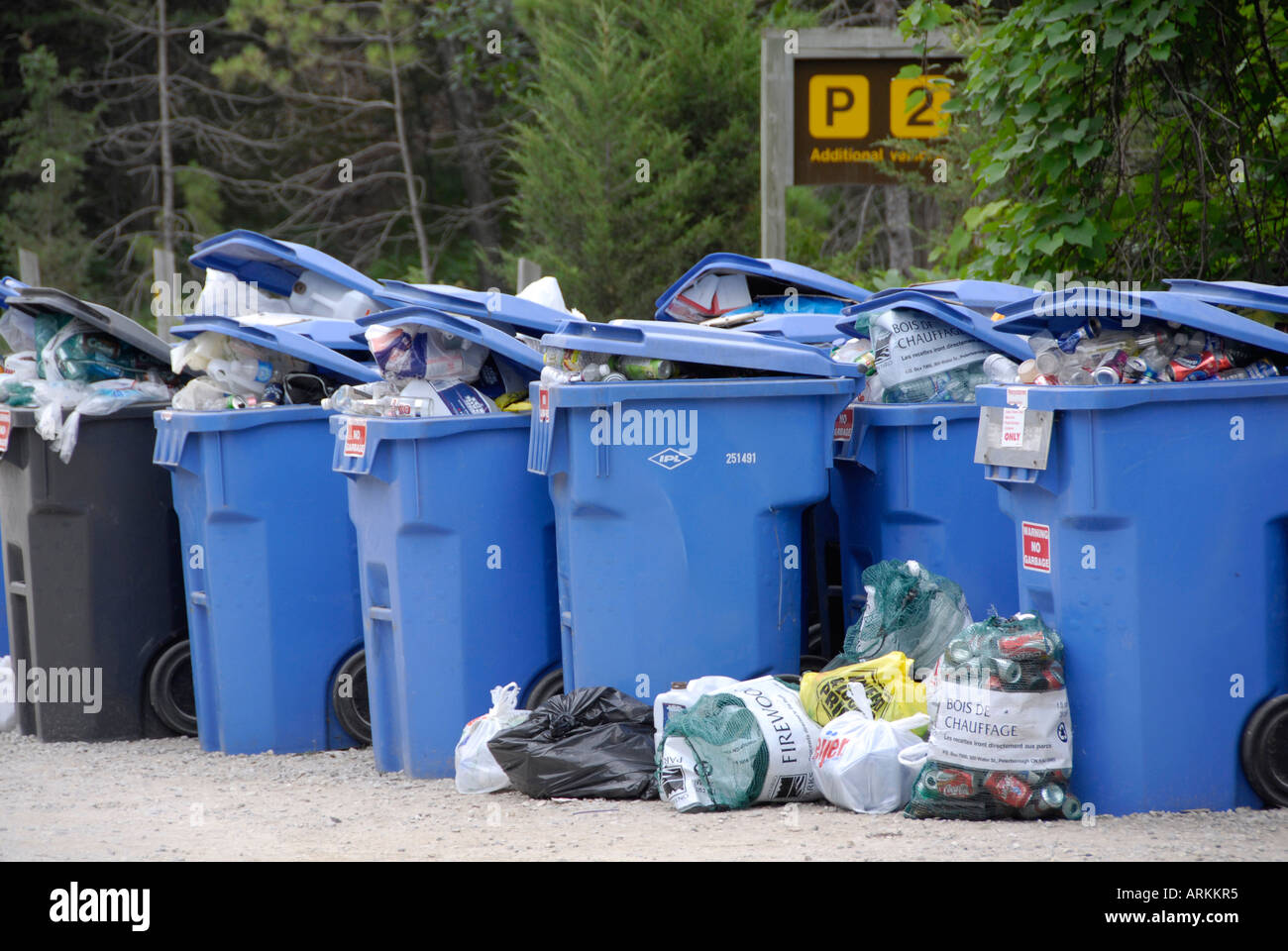 Separate trash containers are set up in a campground to recycle common ...